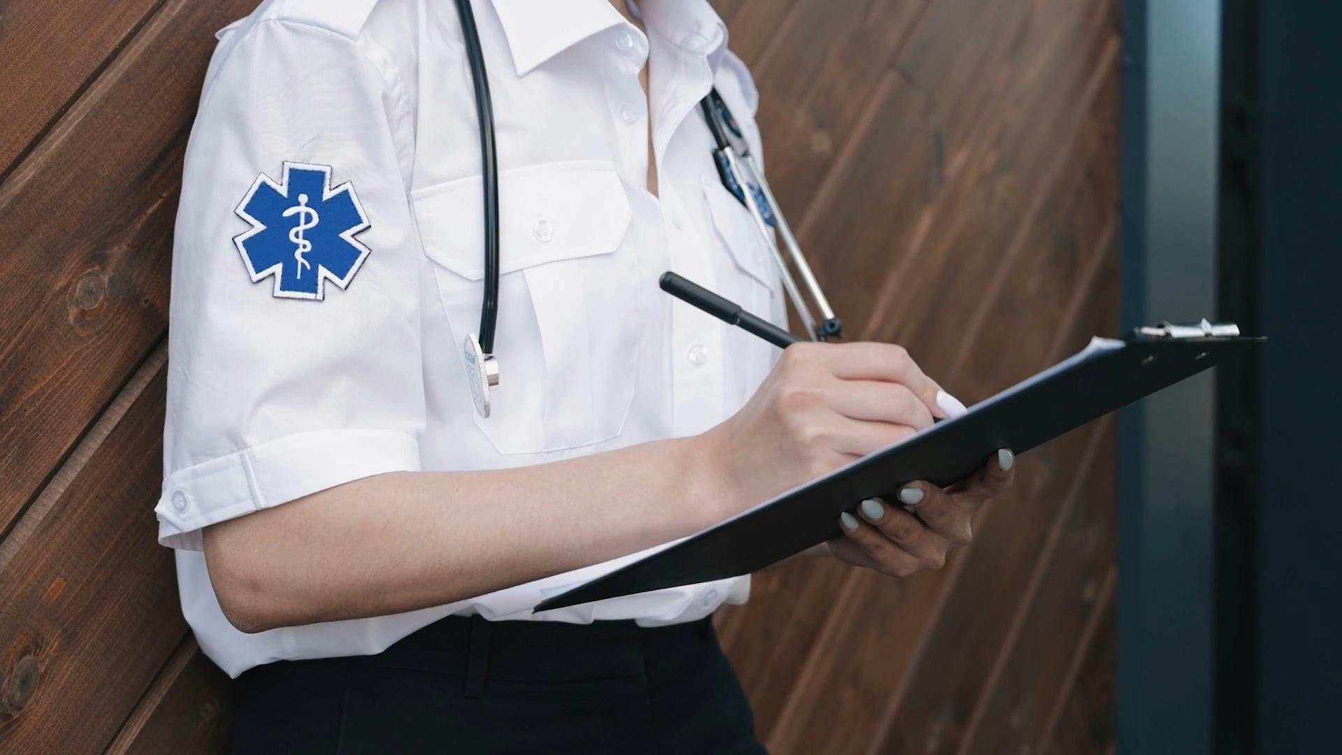 A Paramedic Woman Writing on a White Paper Free Stock Video Footage ...