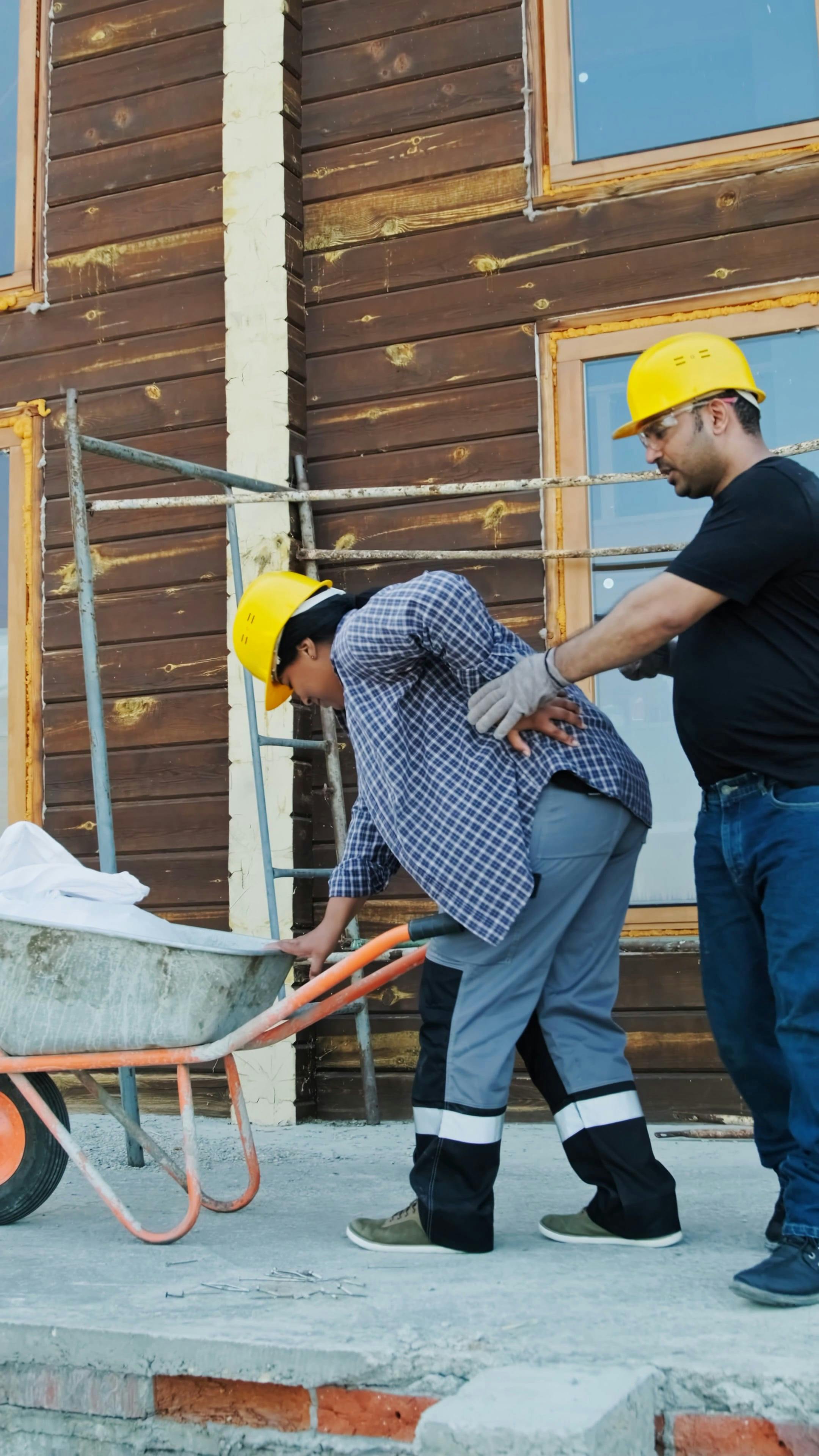 A Man Helping a Female Coworker at a Construction Site · Free Stock Video