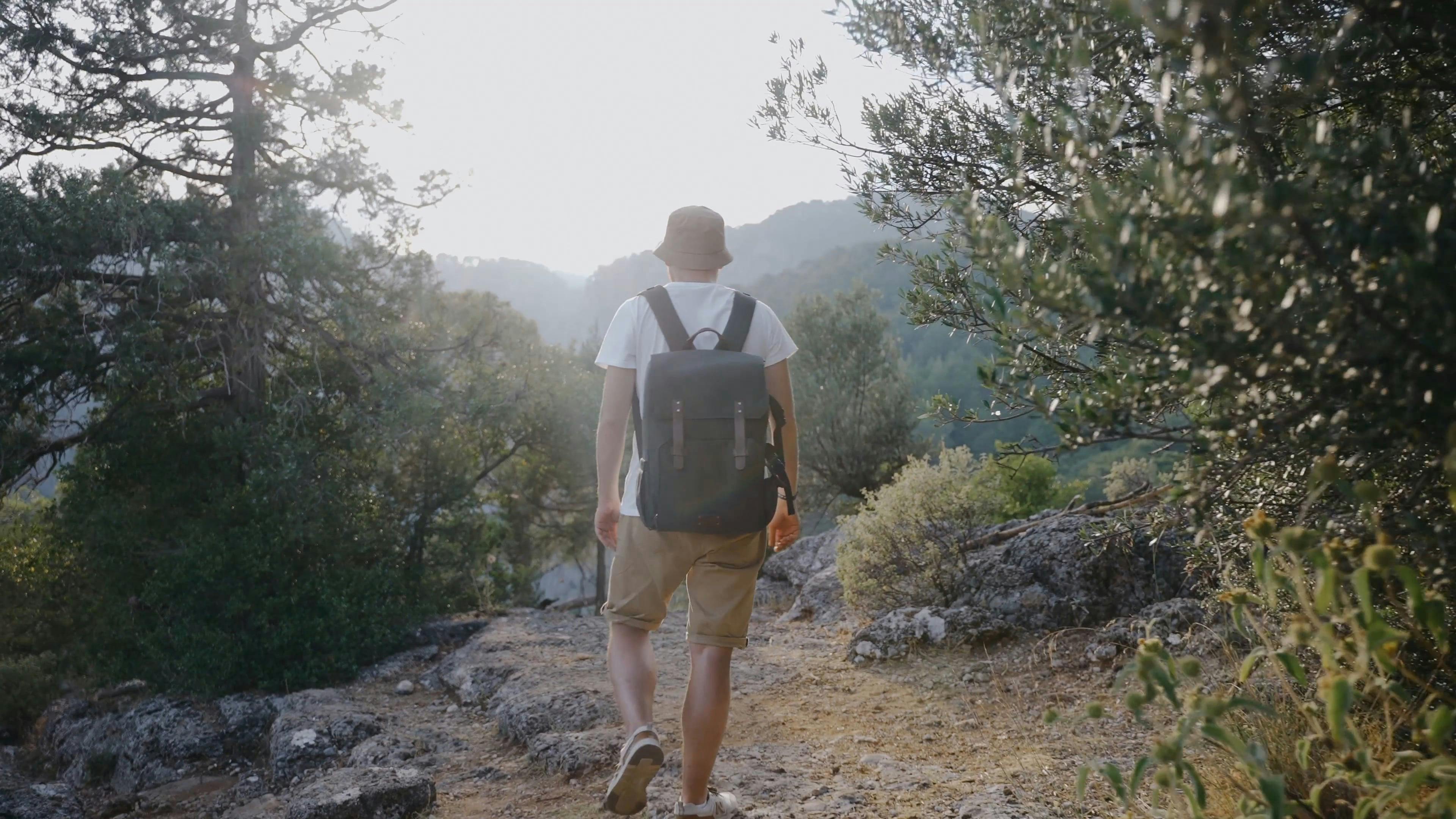 A Man Walking on a Cliff of a Mountain · Free Stock Video