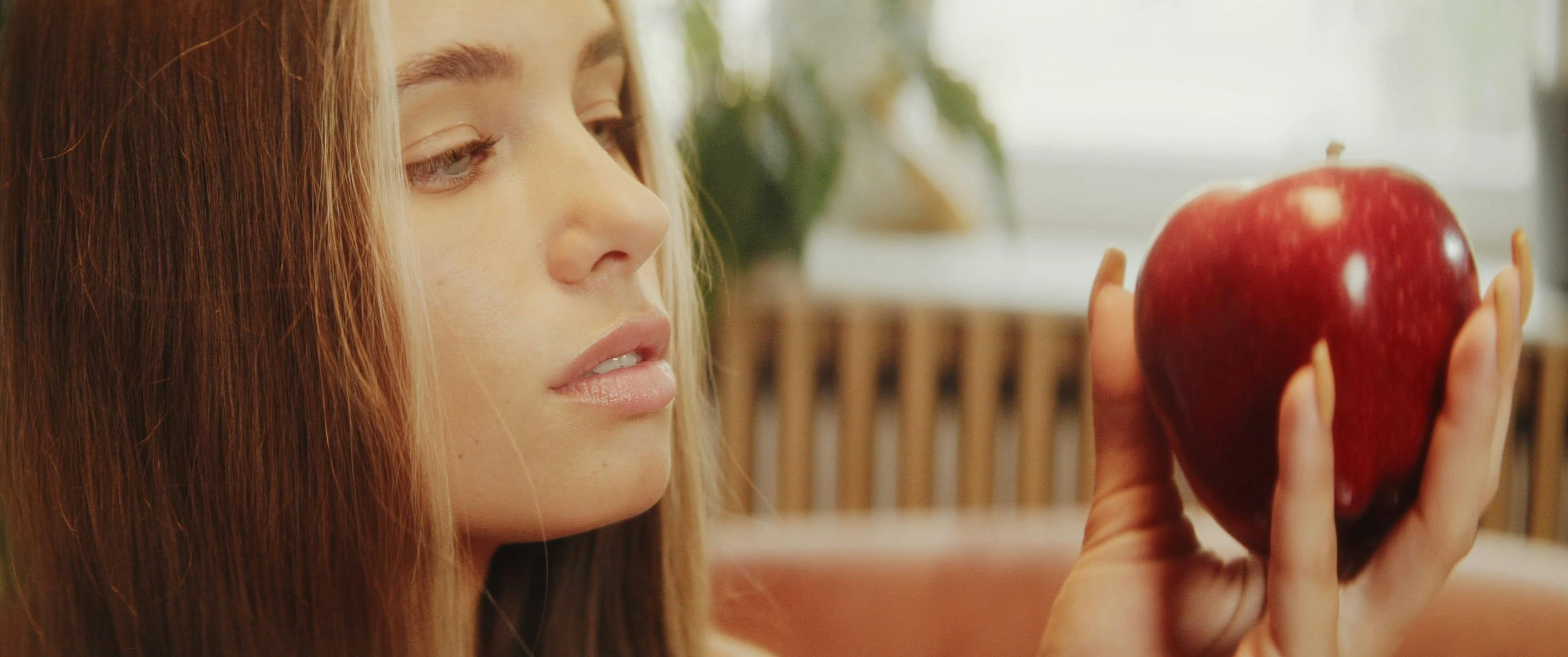 Woman Staring at the Apple Looking at the Camera Free Stock Video ...