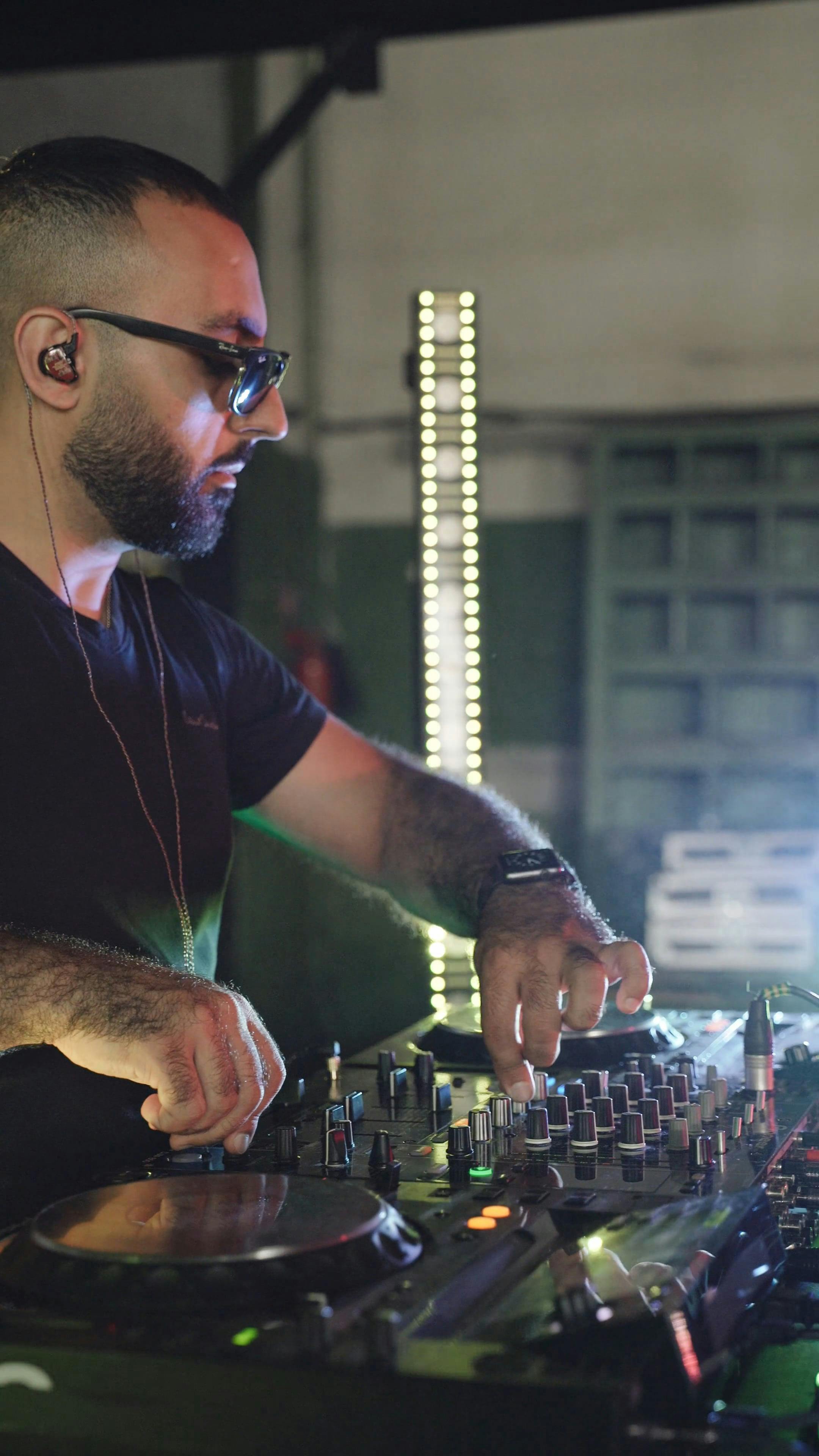 A Disc Jockey Working On His Audio Mixer · Free Stock Video