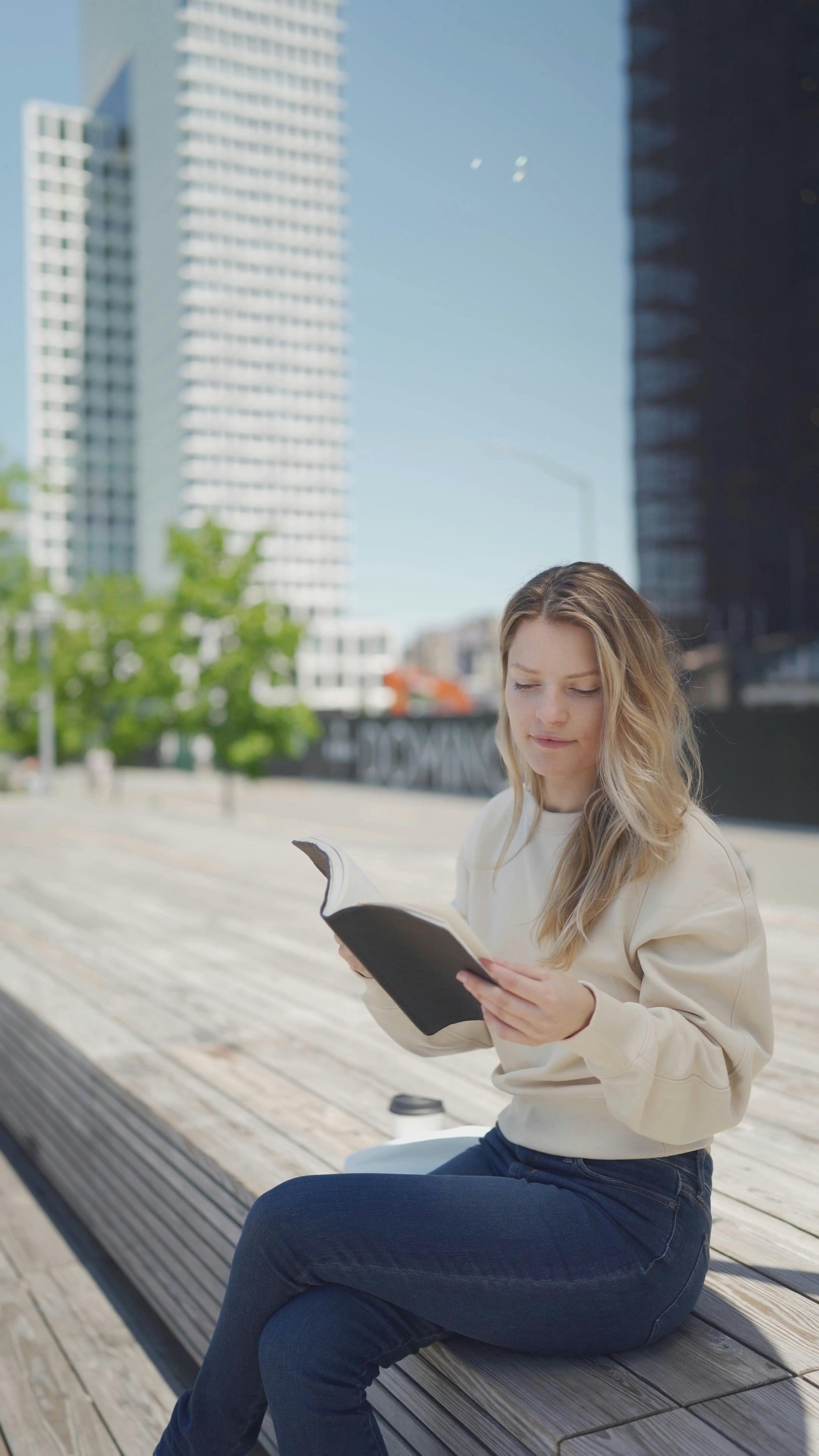 Women Sitting on Bench Reading a Book · Free Stock Video