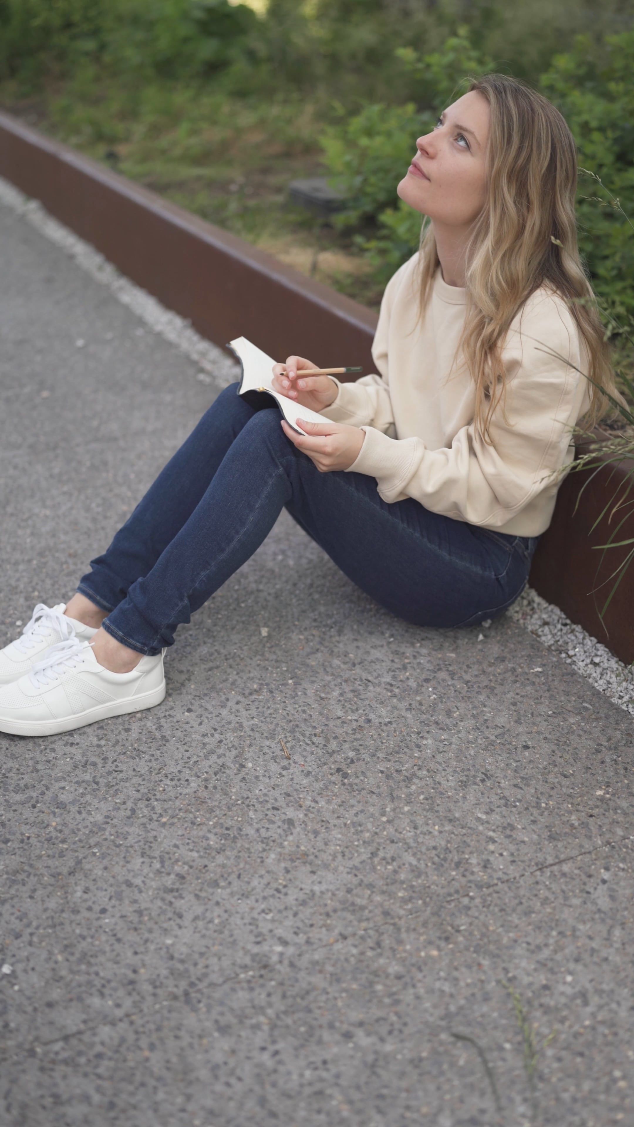 Woman Looking Up While Sitting on the Ground · Free Stock Video
