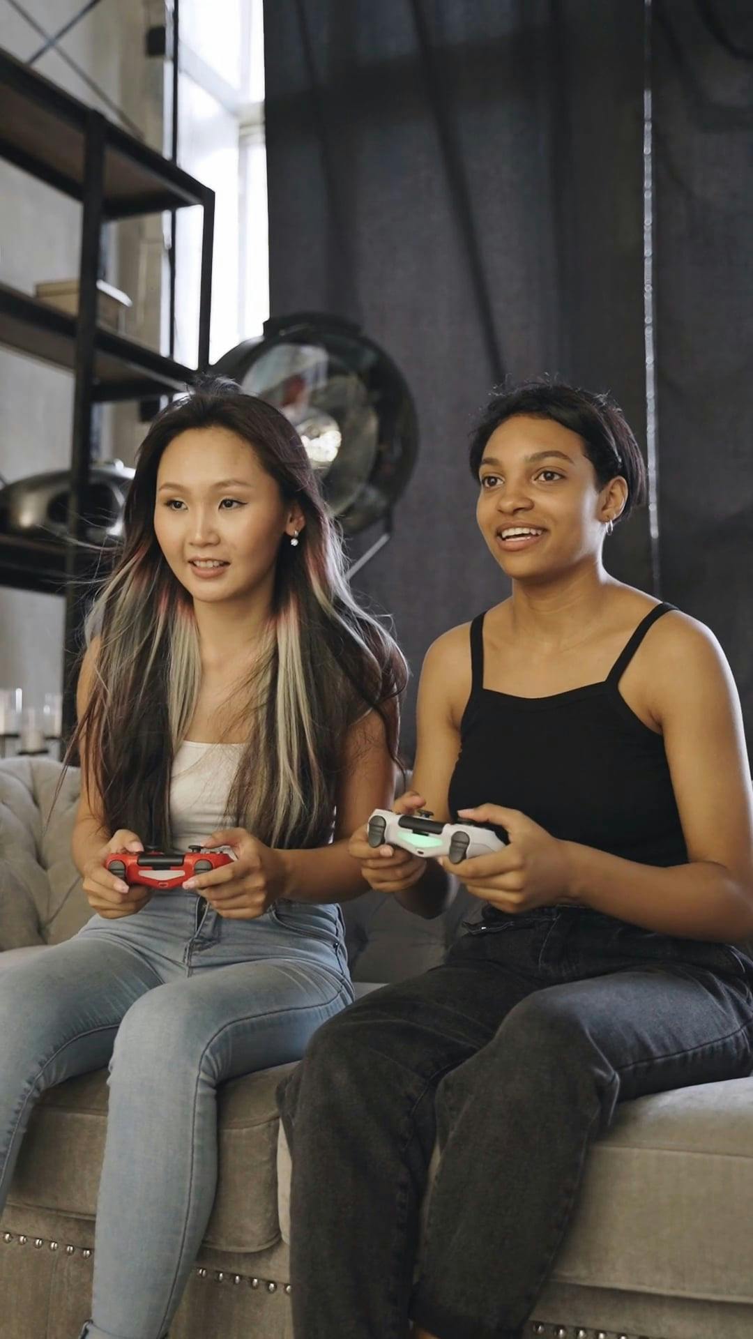 Women Sitting on Sofa Playing Video Games · Free Stock Video
