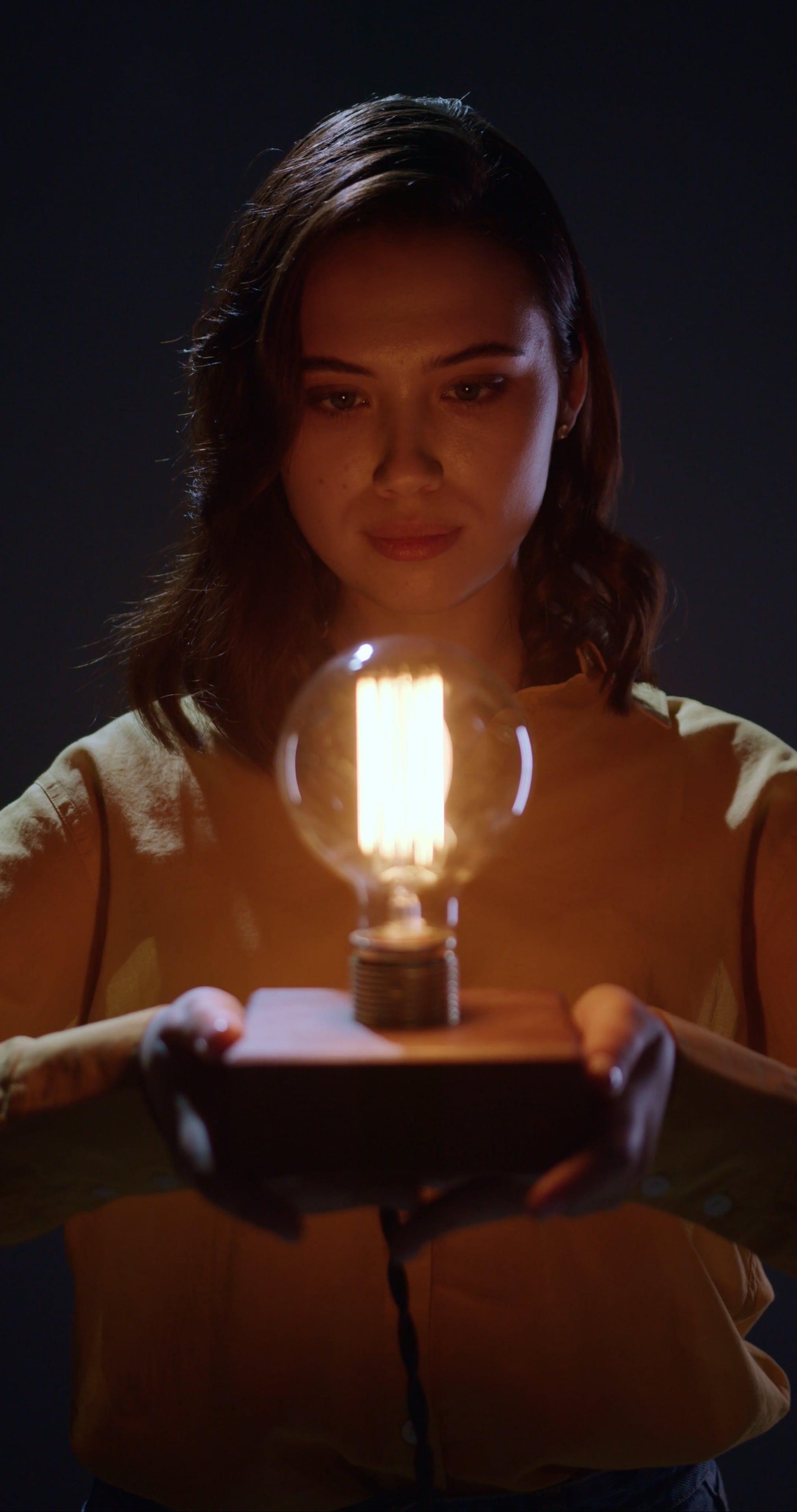 A Woman Holding an Incandescent Light Bulb Free Stock Video Footage ...