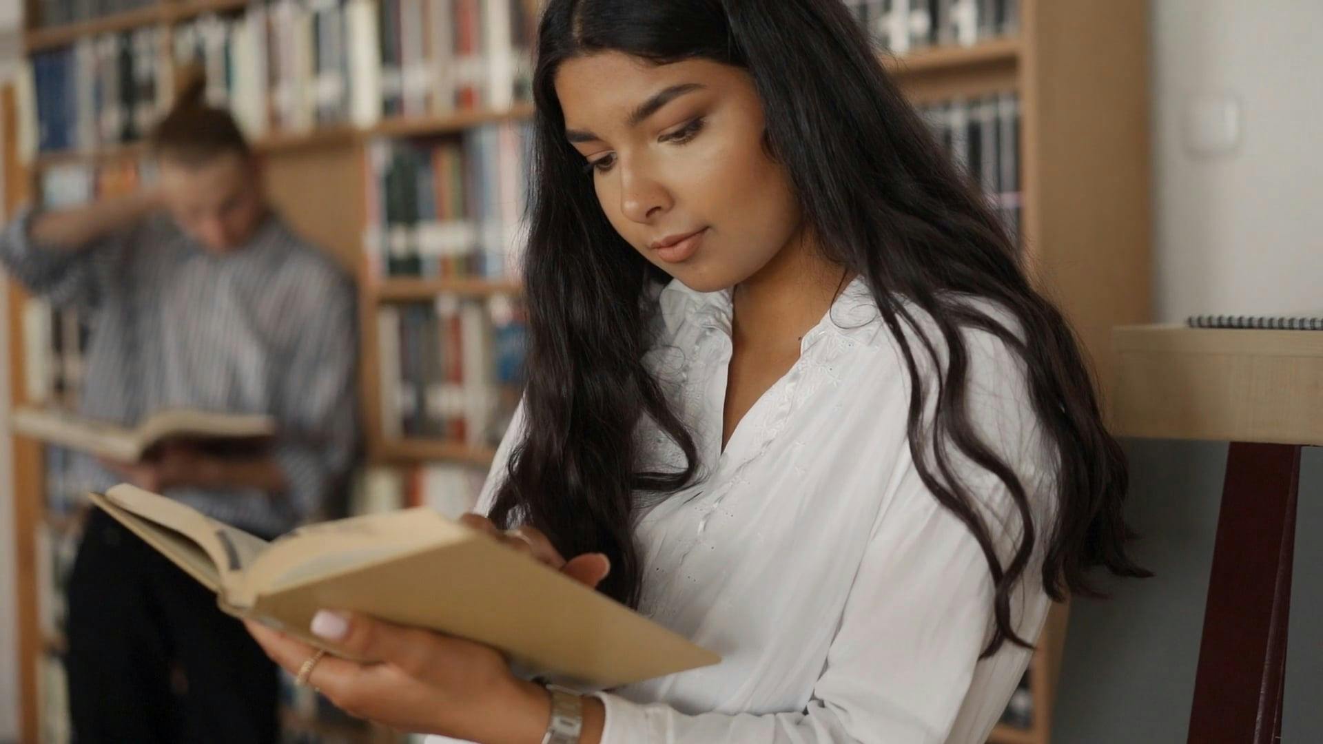A College Student Reading a Book in the Library Free Stock Video ...