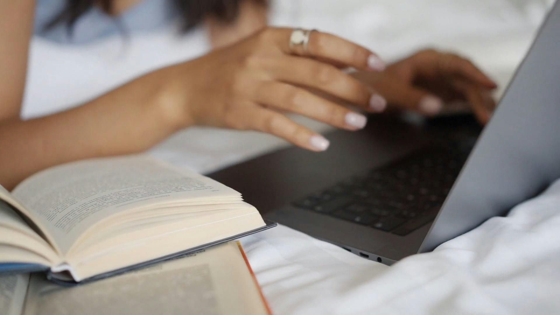 A Woman Typing on Laptop and Reading Book Free Stock Video Footage ...