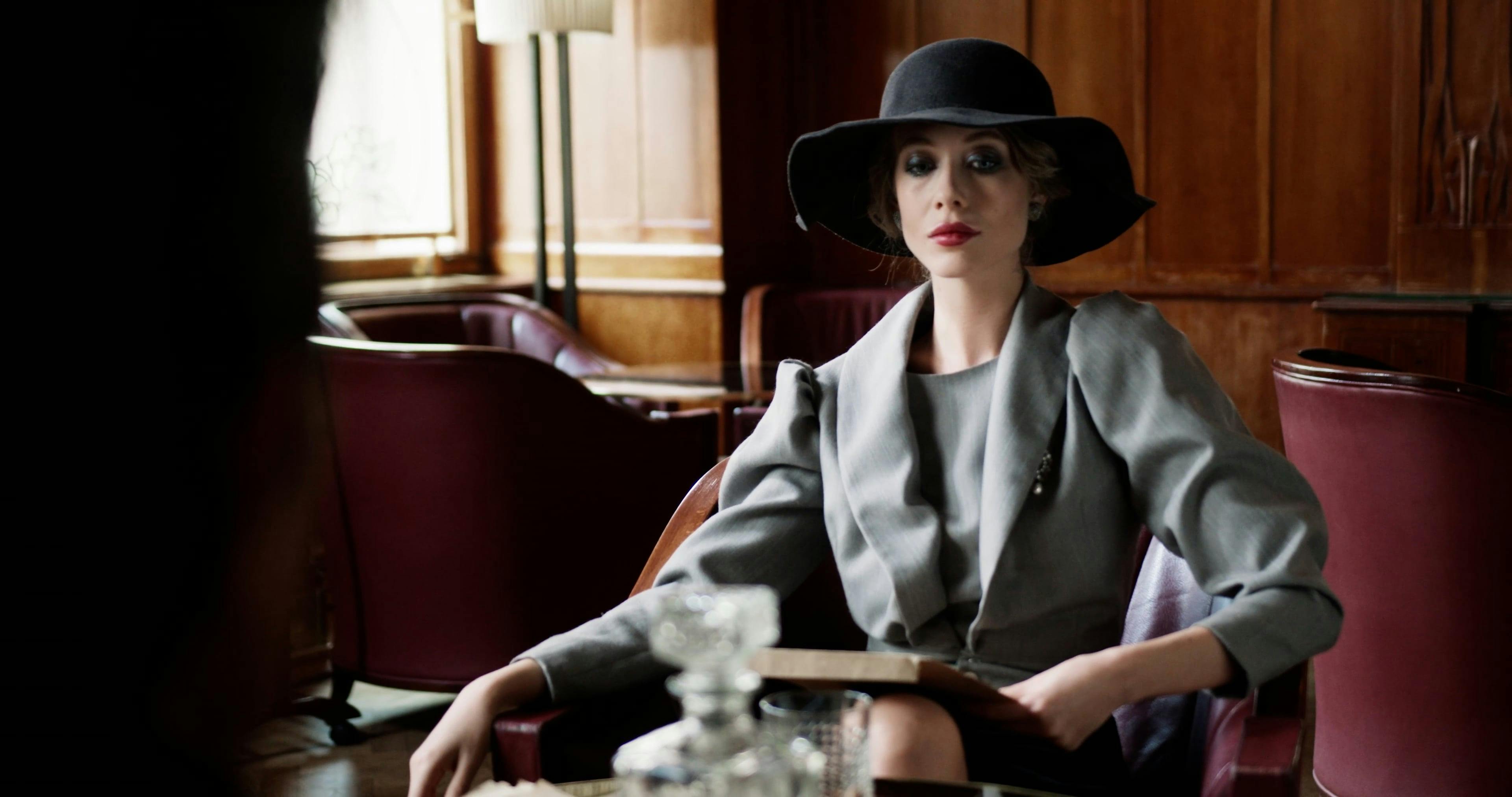 Woman wearing Hat Sitting in Restaurant · Free Stock Video