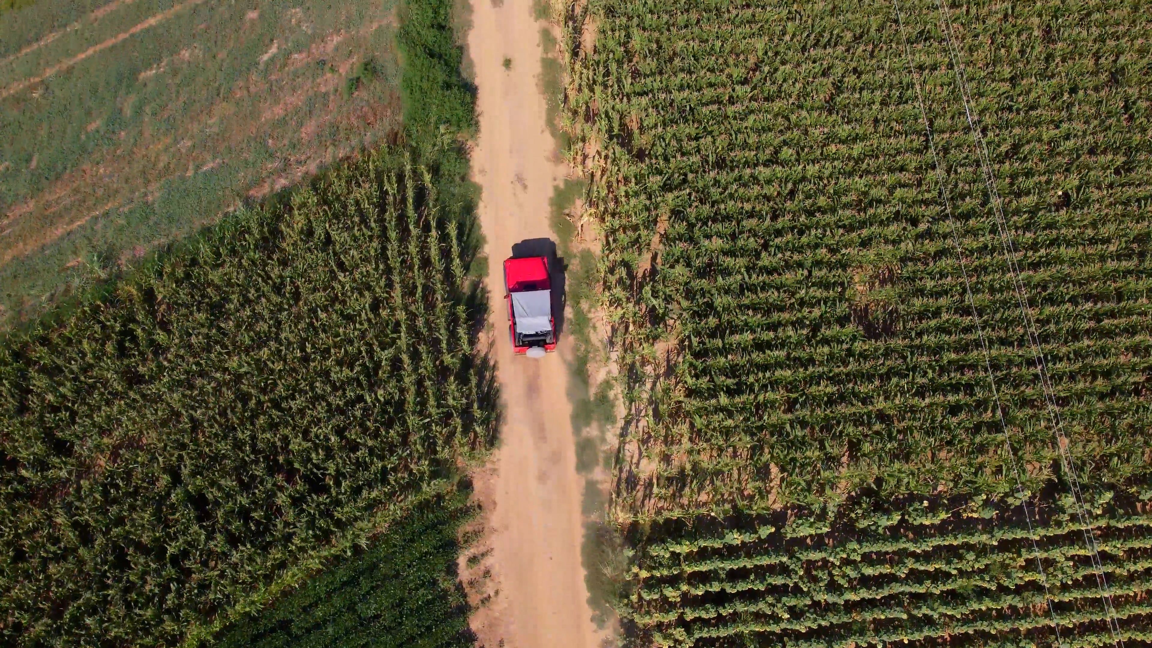 An aerial view of a car driving through a field Free Stock Video ...