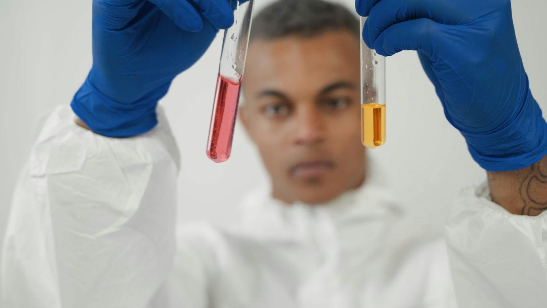 A Man Holding and Shaking Test Tubes · Free Stock Video