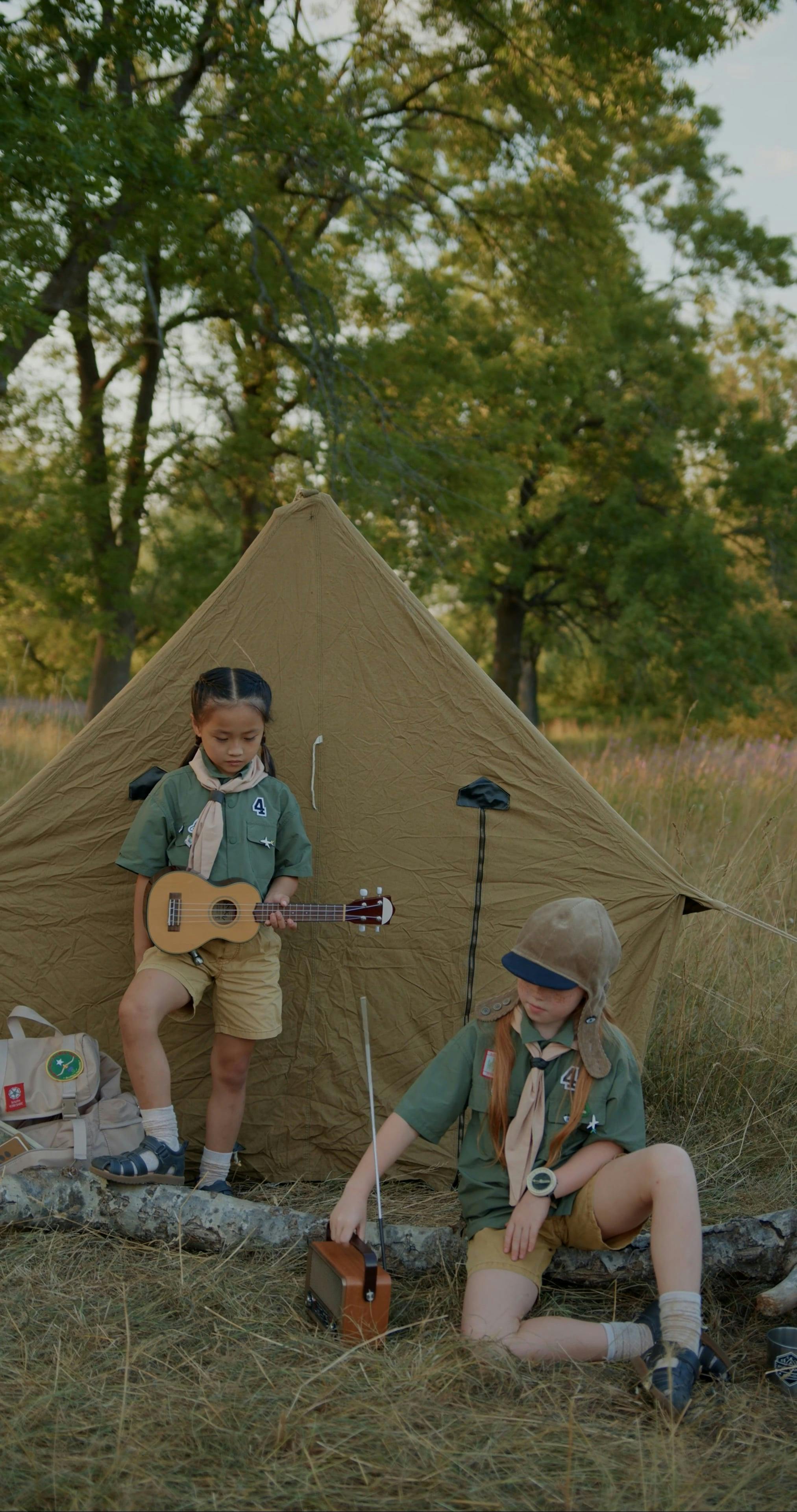 Scouts Eating Together while Sitting on a Log · Free Stock Video