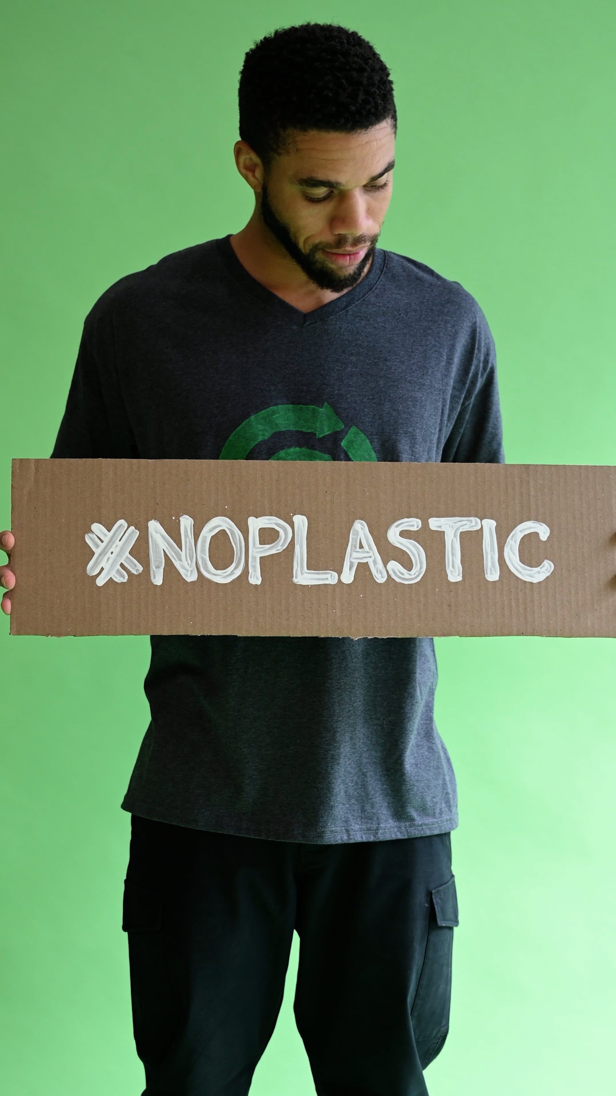 A man holding a sign that says no plastic Free Stock Video Footage ...