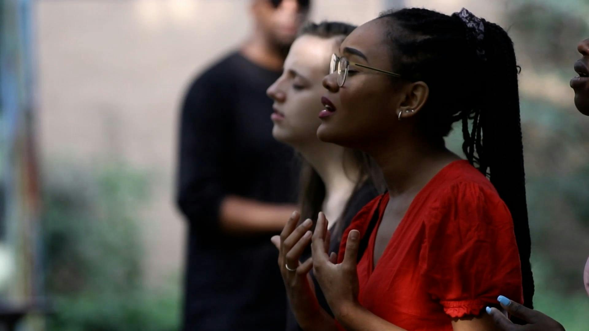 A Woman In Red Jacket Is Crying While In Worship At A Religious Event ...