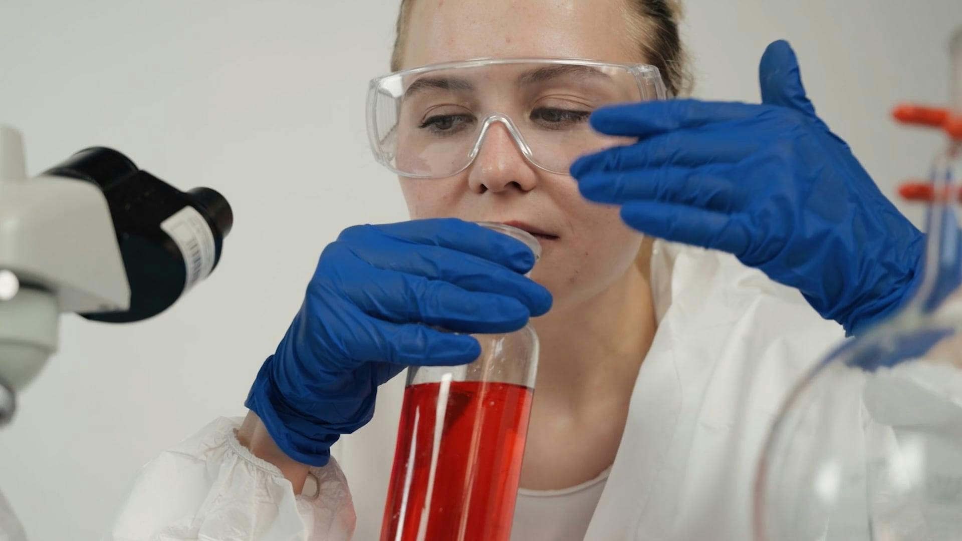 A Scientist Smelling Colored Liquid in a Glass Bottle · Free Stock Video