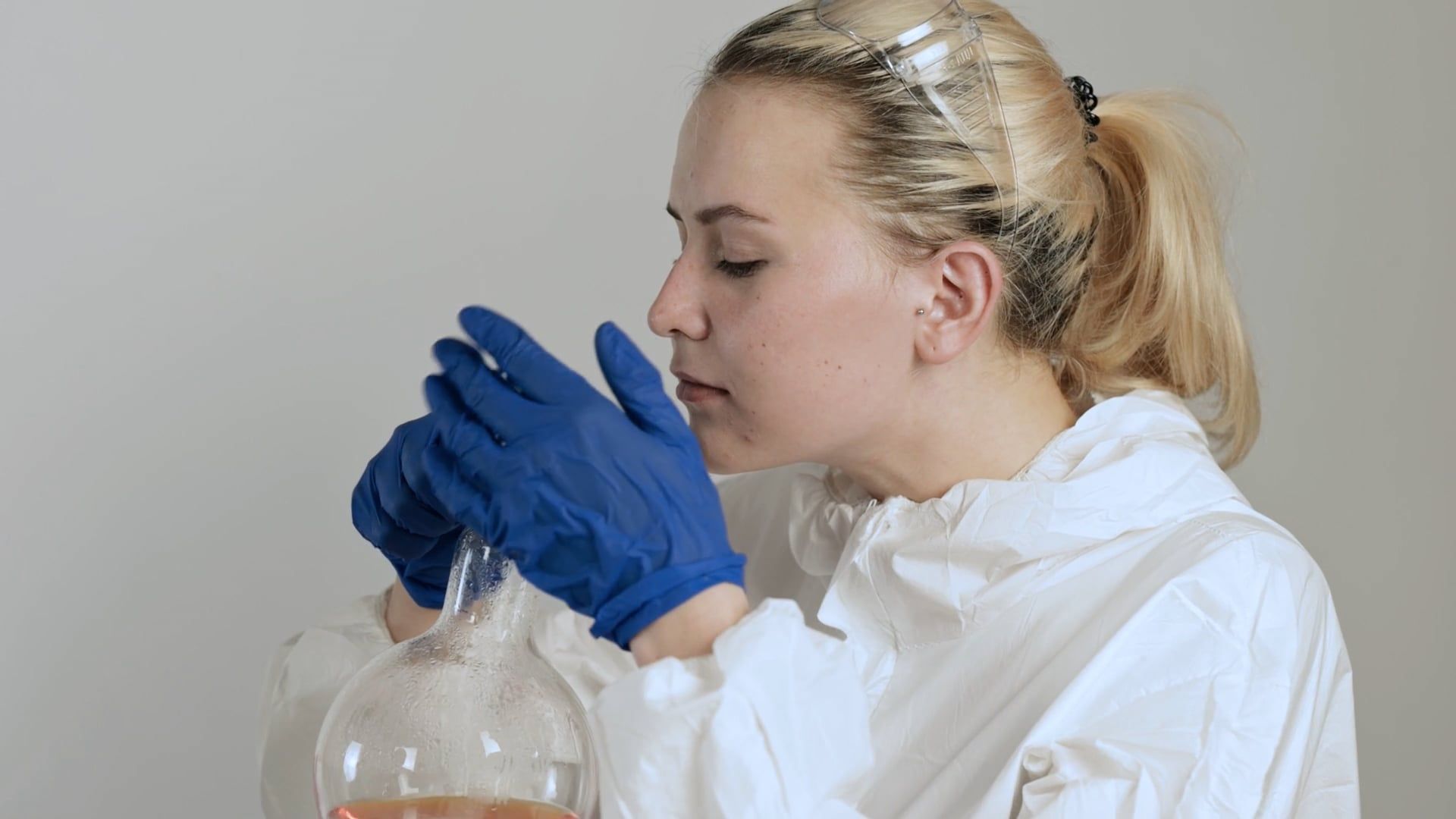 A Female Scientist Smelling Colored Liquid in a Flask Free Stock Video ...