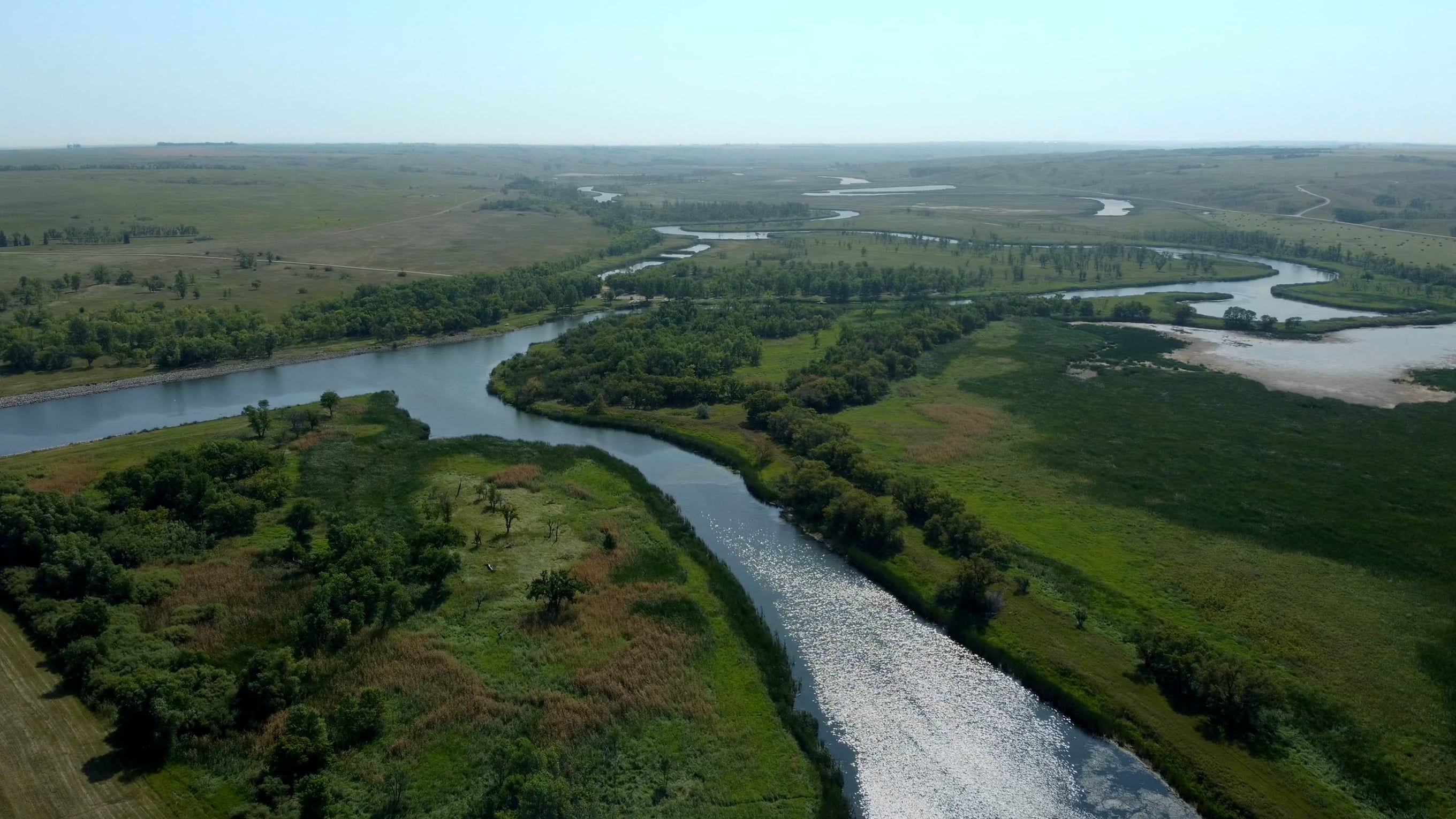 An aerial view of a river and grassy plains Free Stock Video Footage ...