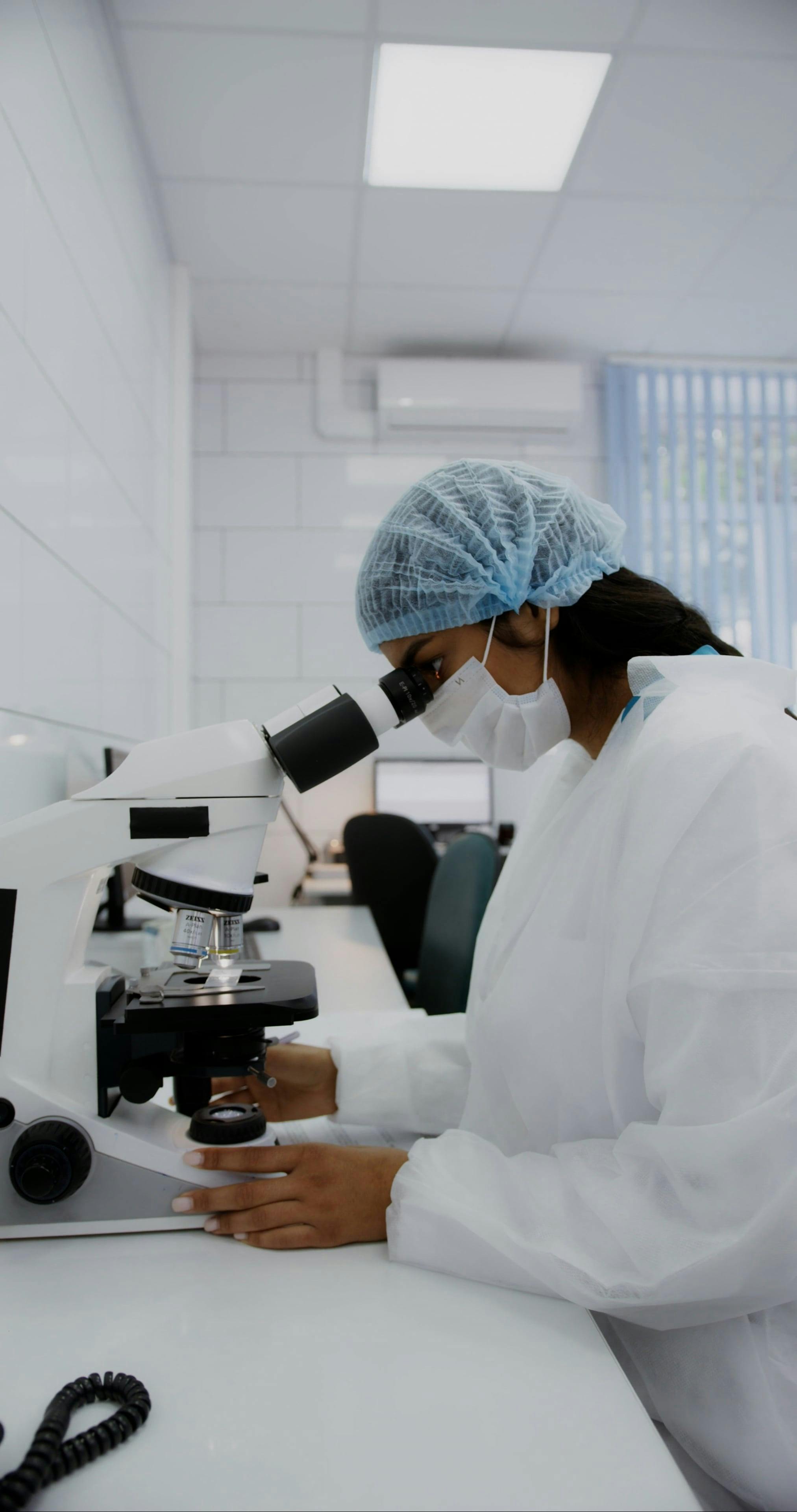 A Female Scientist Using a Microscope in a Laboratory Free Stock Video ...