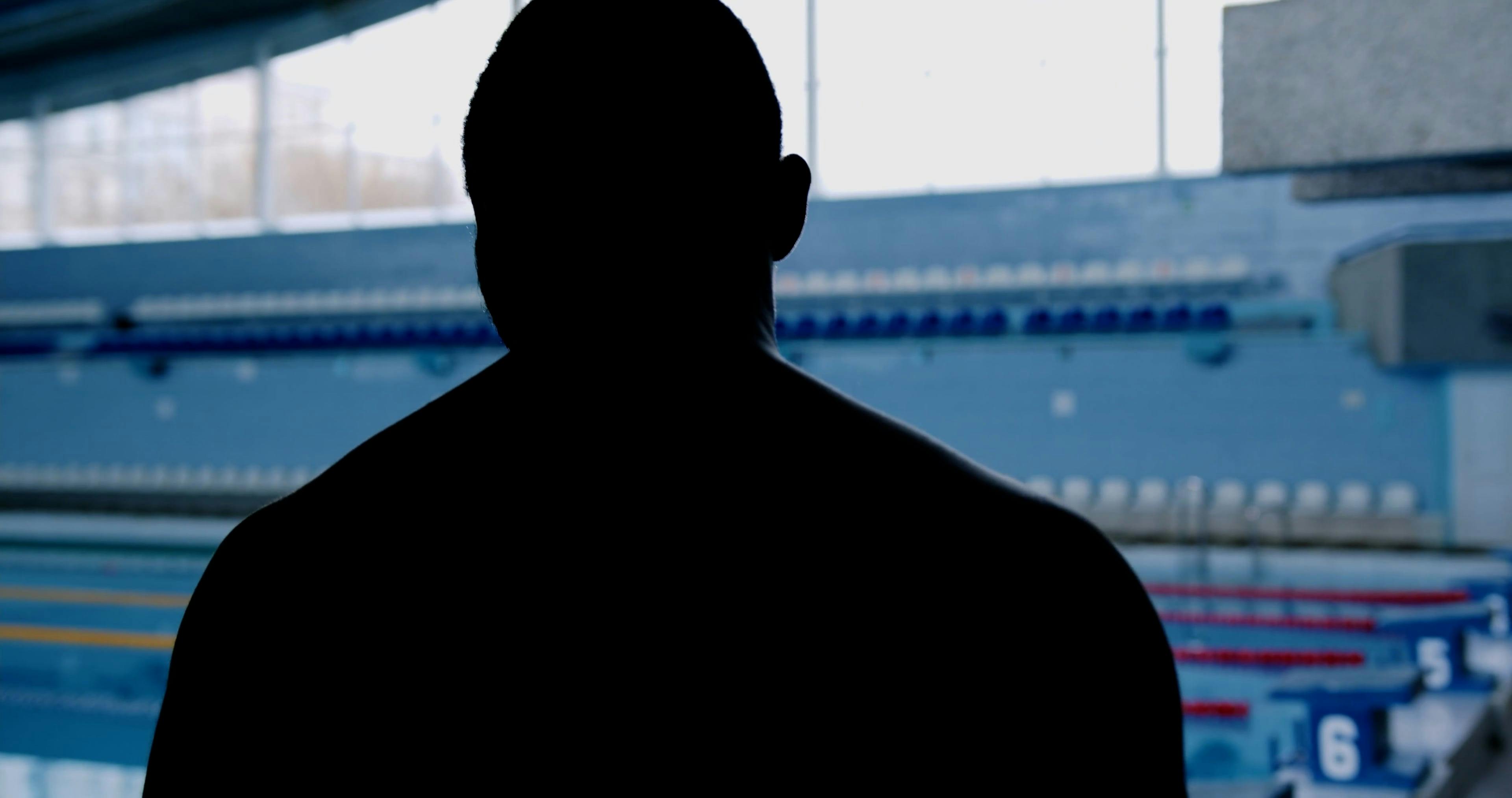 Rear view of black man walking at swimming pool Free Stock Video ...