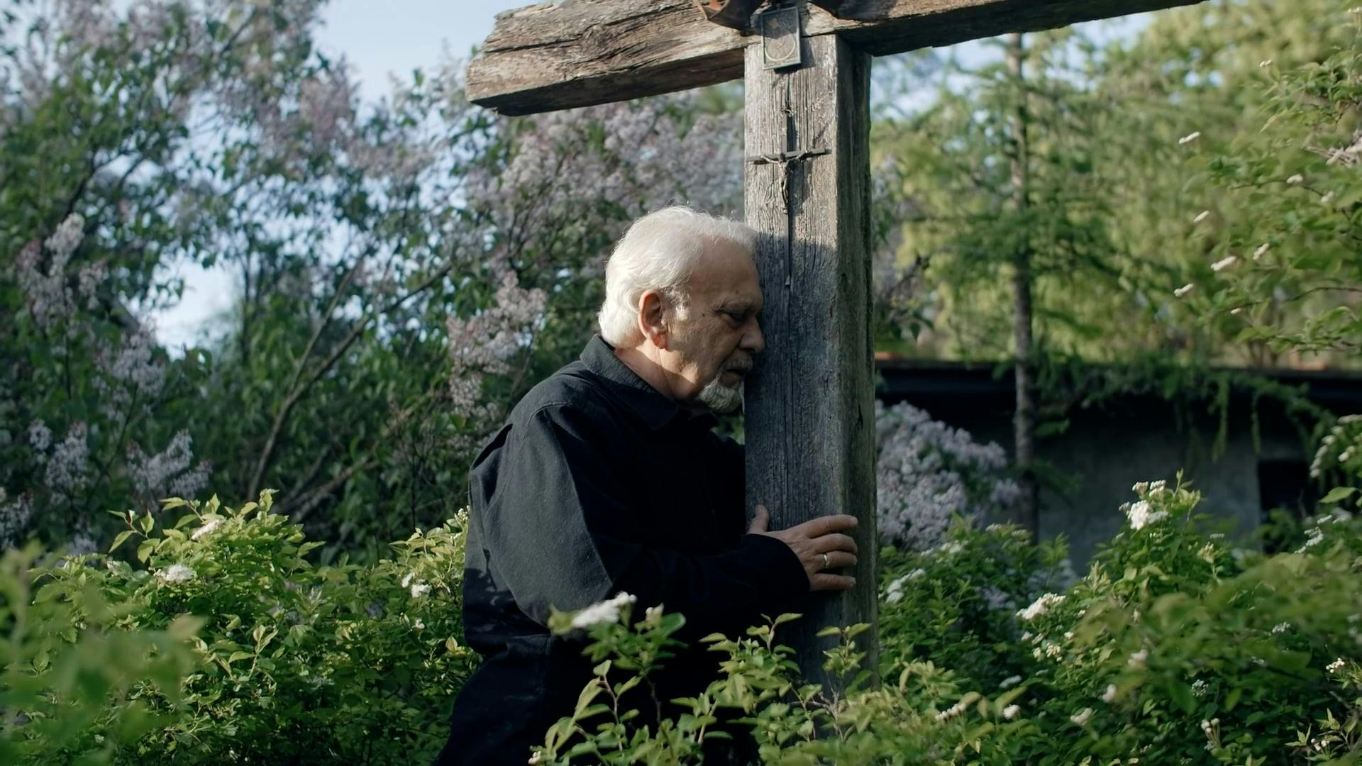 A Grieving Elderly Man Embracing a Wooden Cross Free Stock Video ...