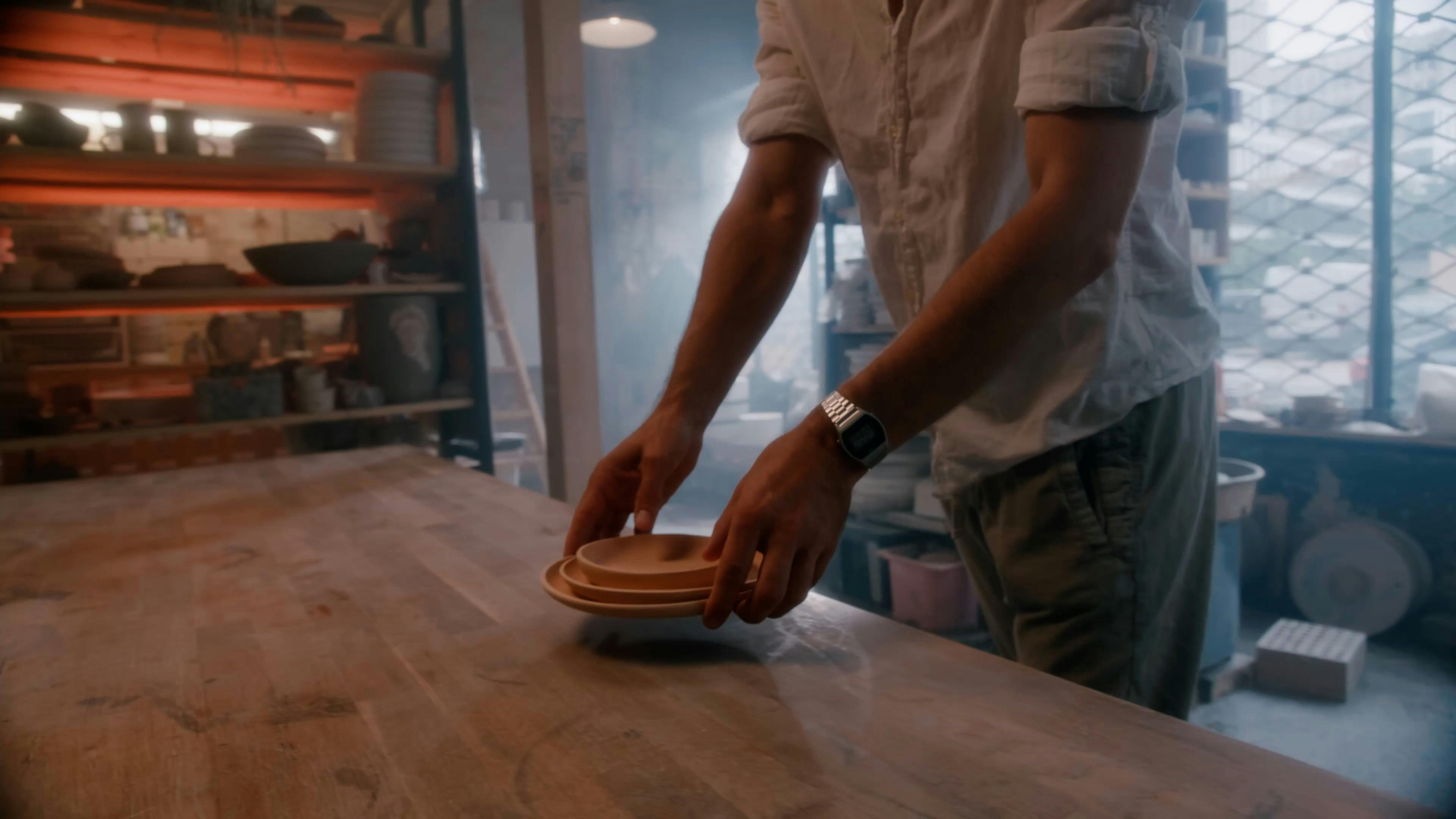A Man Putting Stacked Plates on a Wooden Table Free Stock Video Footage ...