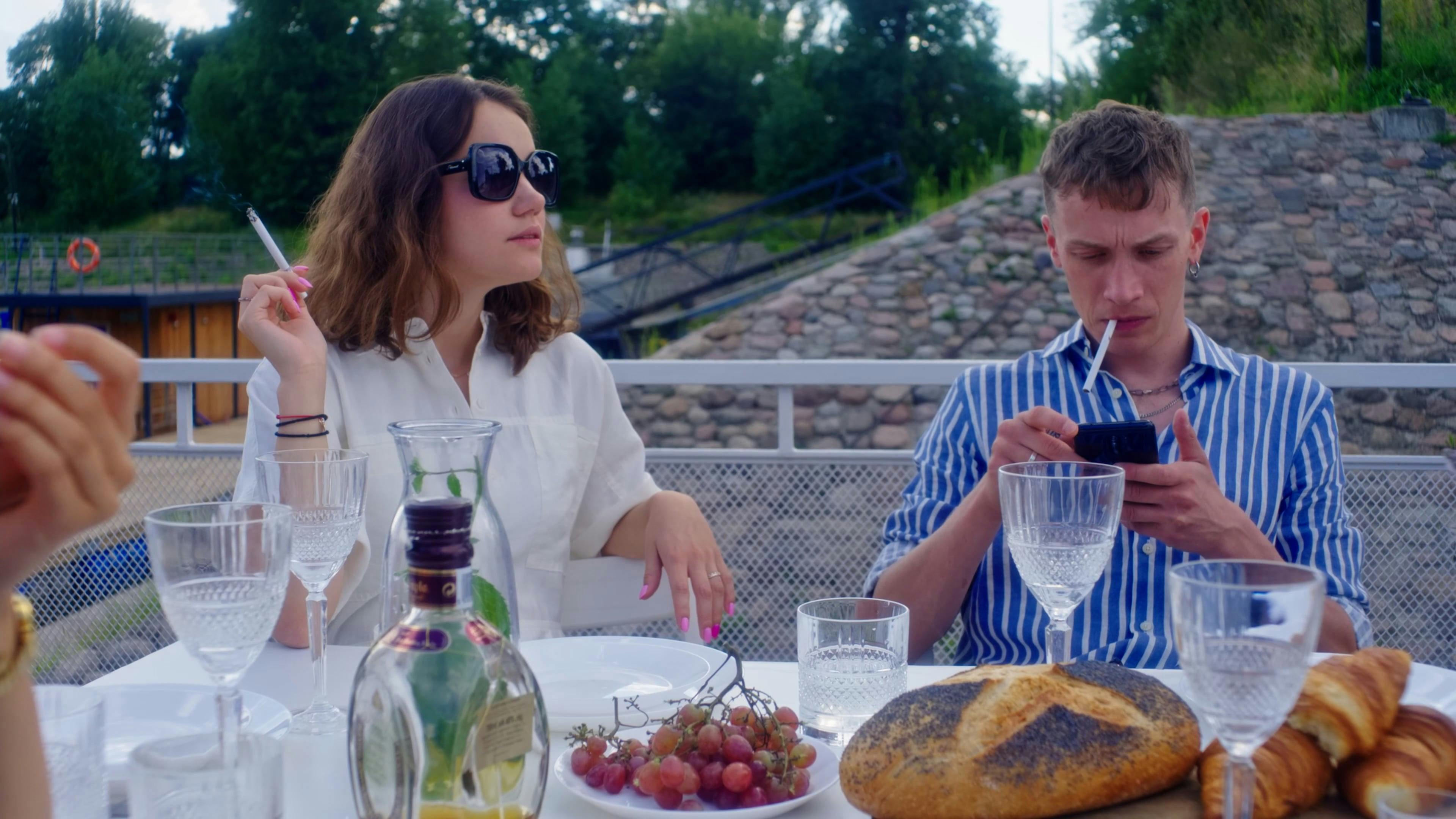 A Man and Woman Smoking in Front of the Dining Table Free Stock Video ...