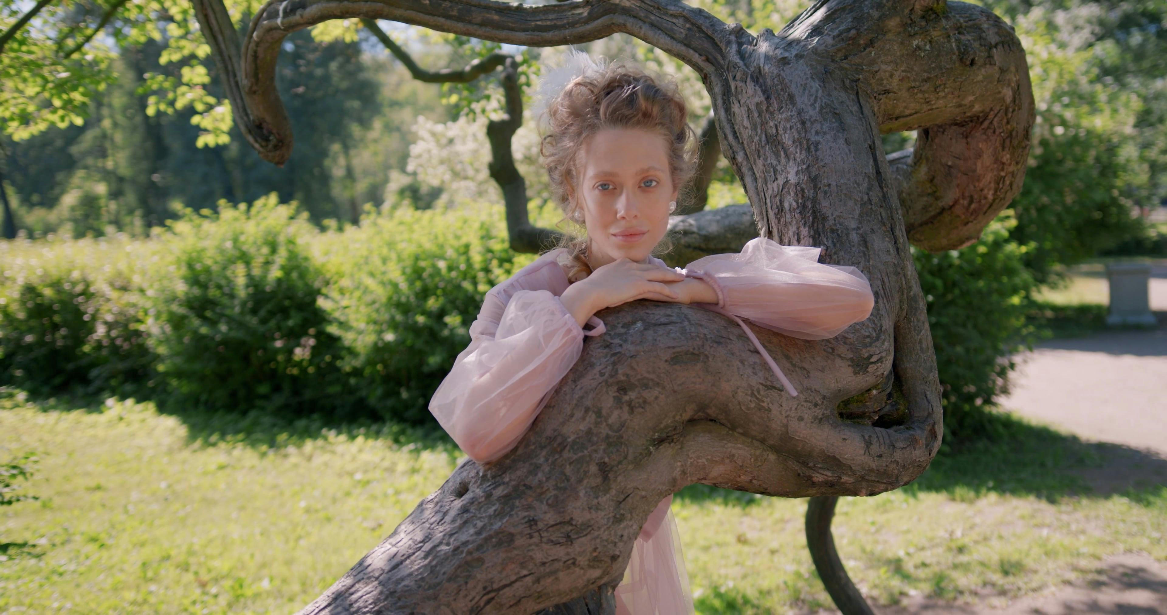 Woman Leaning on a Tree Trunk Free Stock Video Footage, Royalty-Free 4K ...
