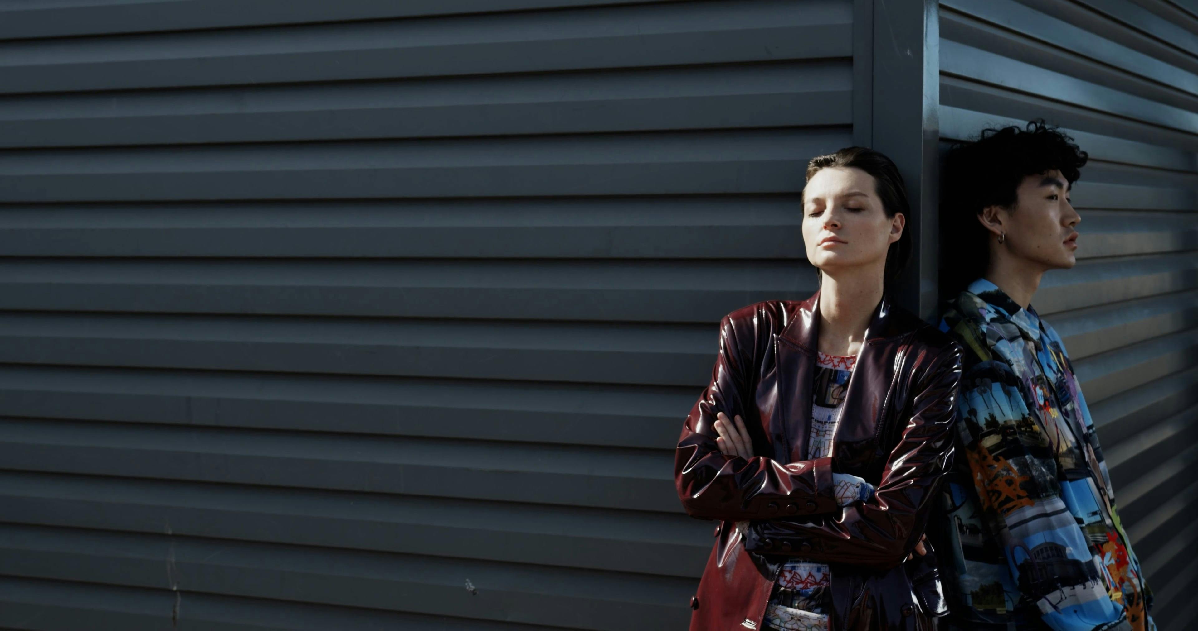Models Leaning on a Metal Gate While Seriously Looking at Camera Free ...