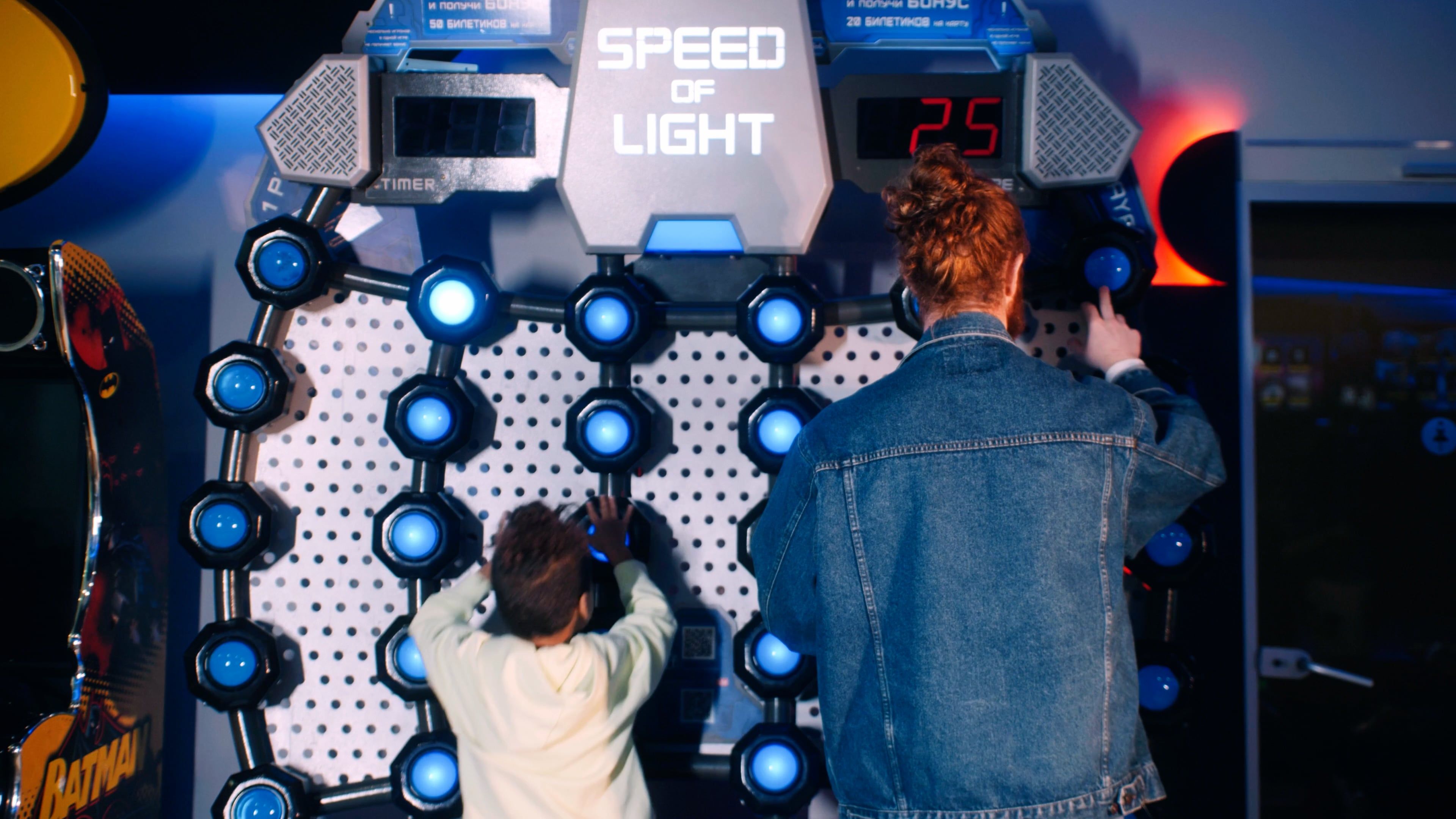 Back View of a Father and his Son Playing an Arcade Game Free Stock ...