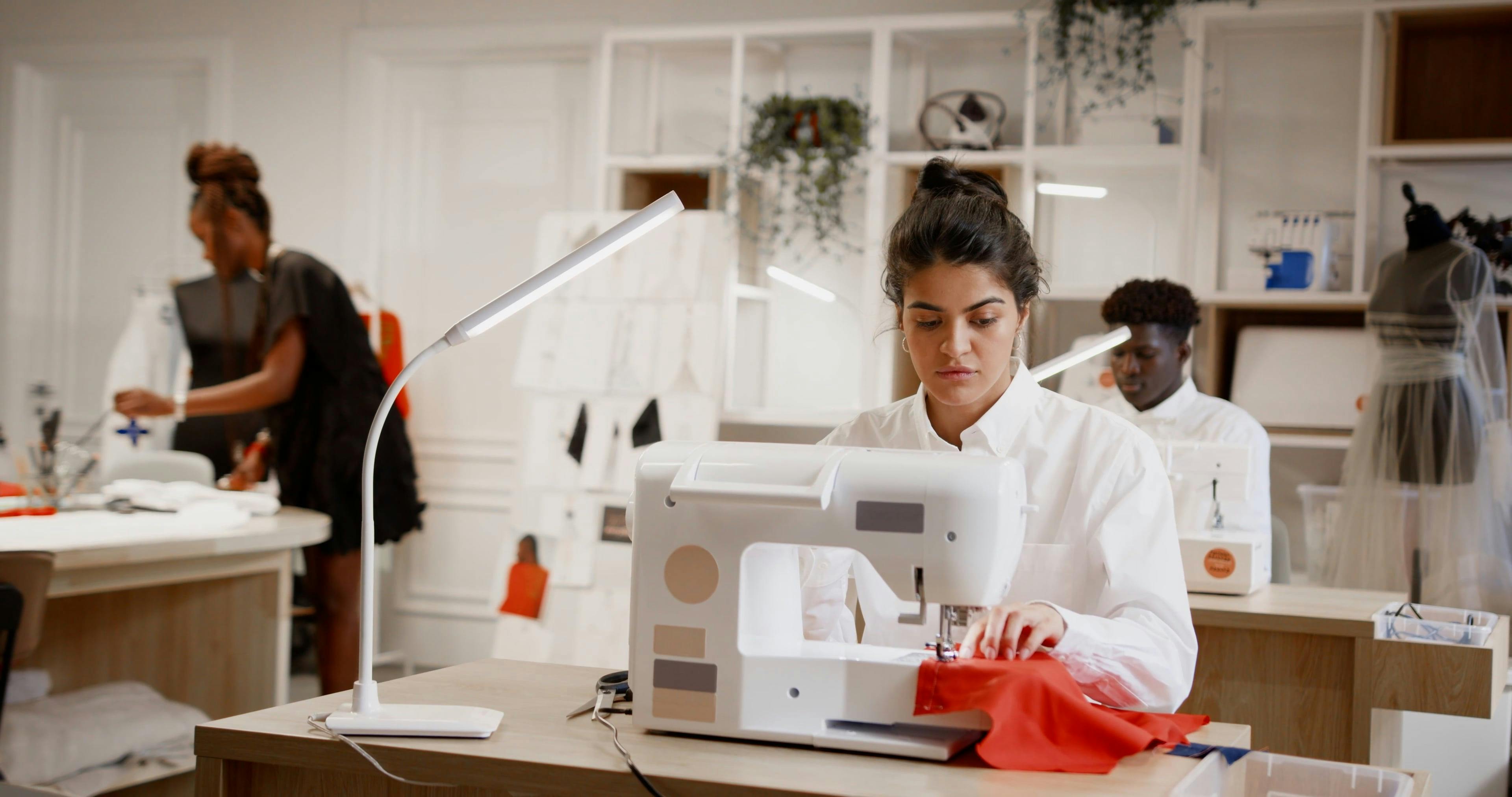 A Man and a Woman Working using Sewing Machines Free Stock Video ...