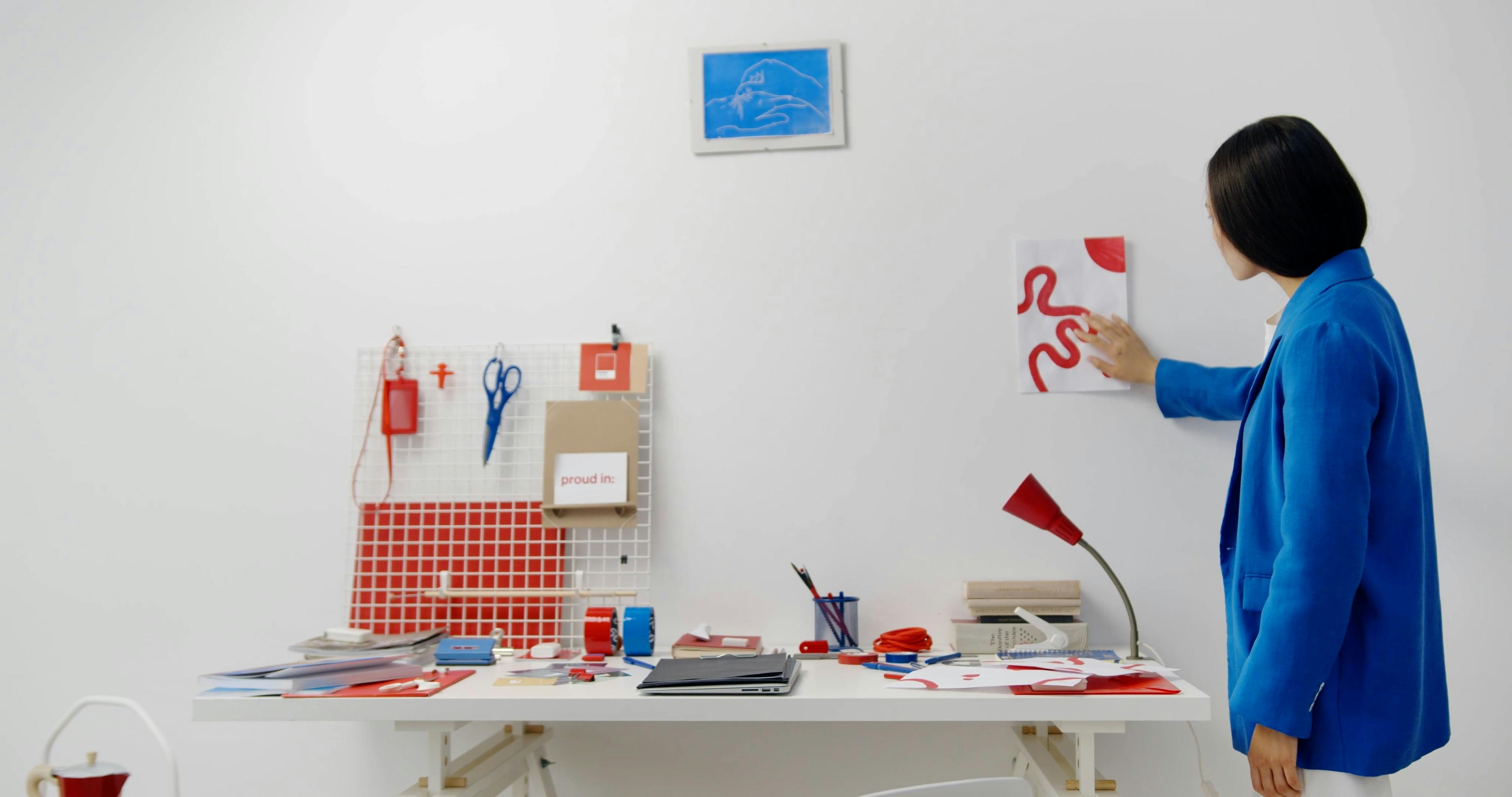 A Woman Taping Papers with Drawings on the Wall Free Stock Video ...