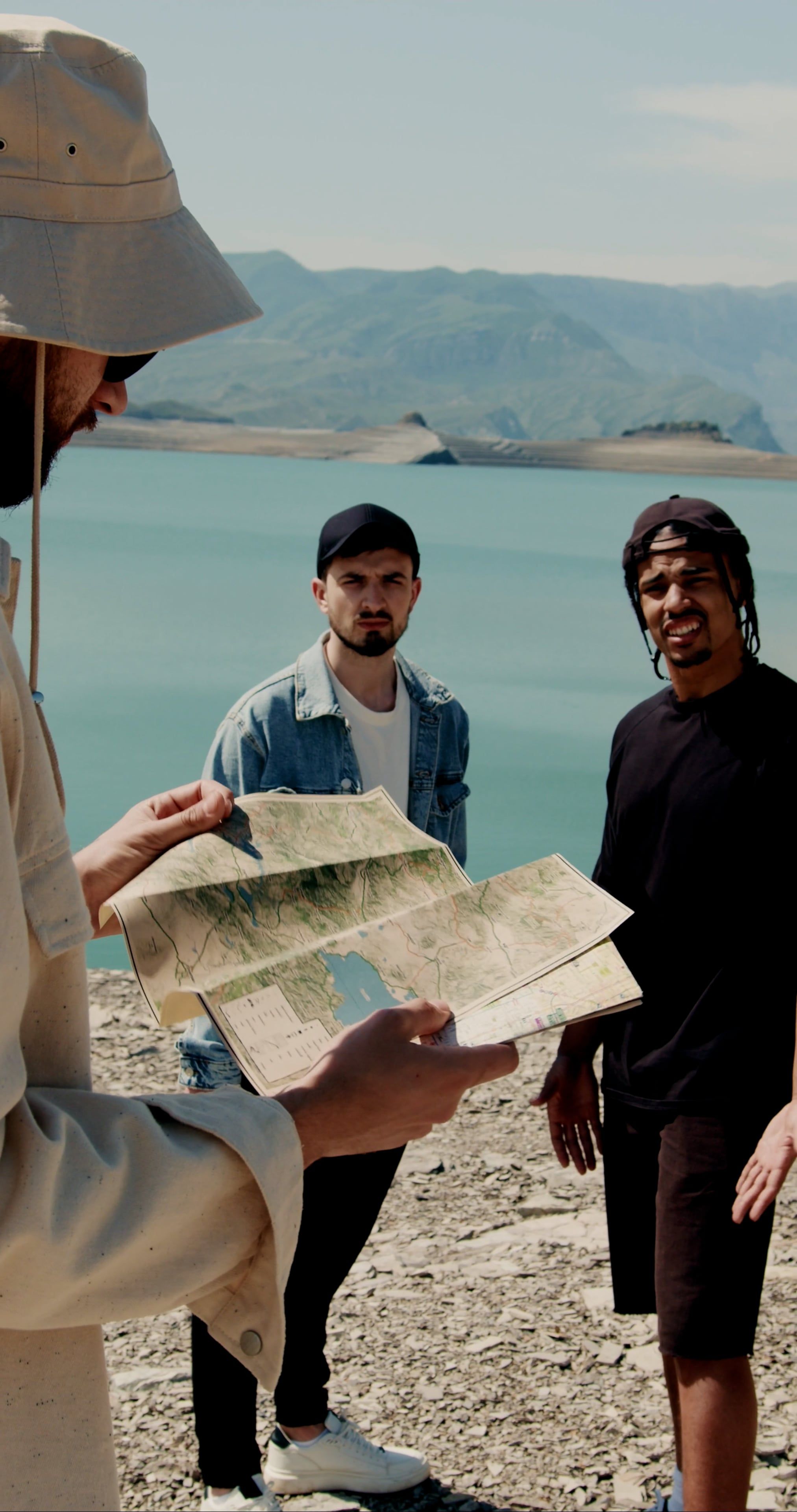 Men Looking at a Man Checking Directions on a Map Free Stock Video ...